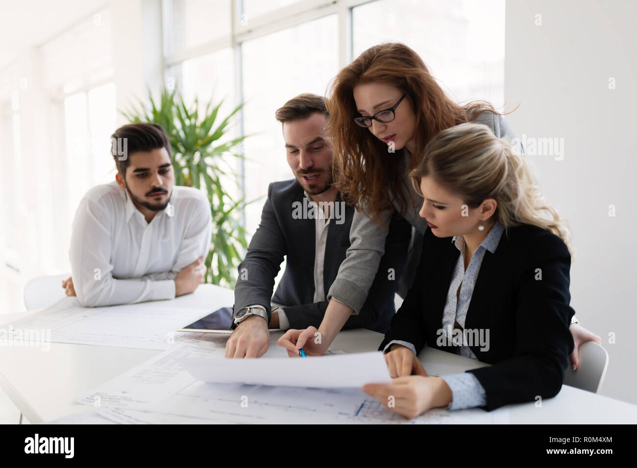 Group of architects working together on project Stock Photo - Alamy