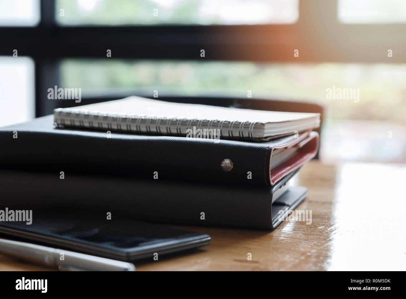Stack of notebooks and pens on office desk Stock Photo - Alamy
