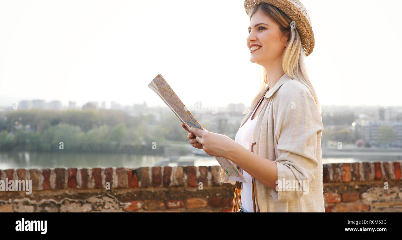Happy tourist woman on vacation with map visiting city Stock Photo - Alamy