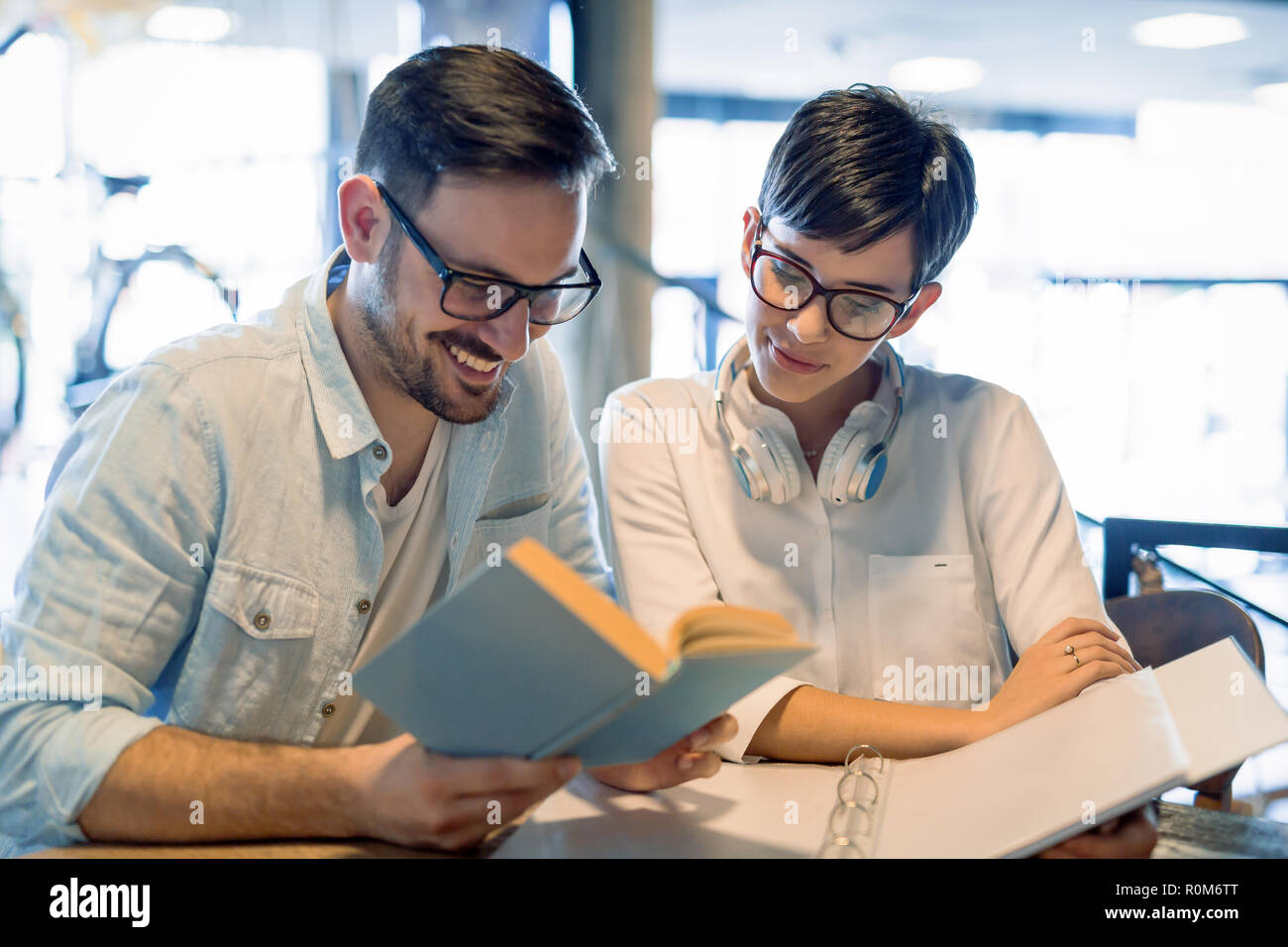 Young beautiful students studying in modern library Stock Photo - Alamy