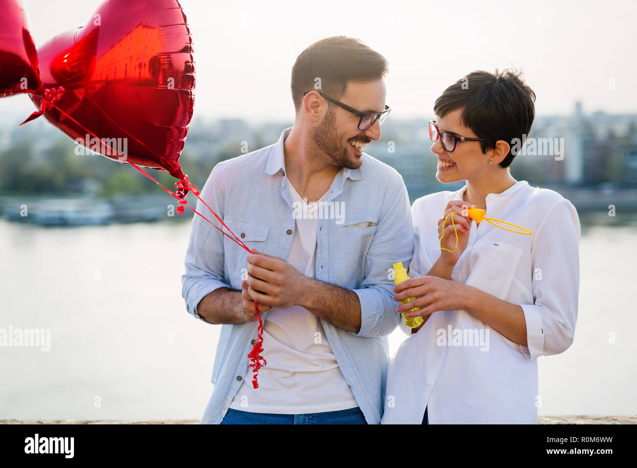 smiling couple in love with balloons on sunset Stock Photo - Alamy