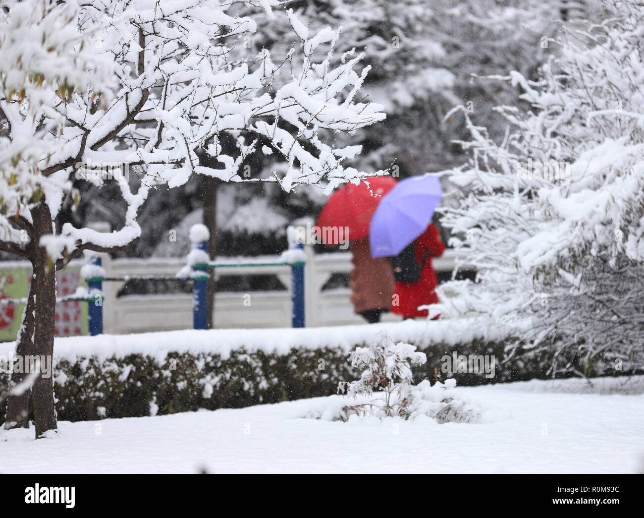 Pingliang, China's Gansu Province. 5th Nov, 2018. Citizens walk as it ...