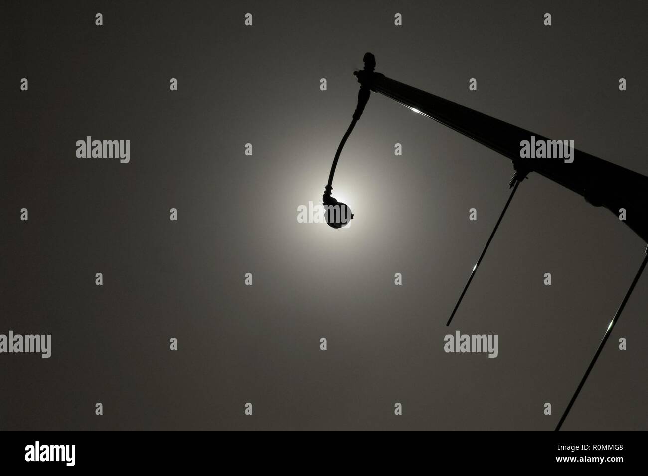 light post covering the sun Stock Photo - Alamy