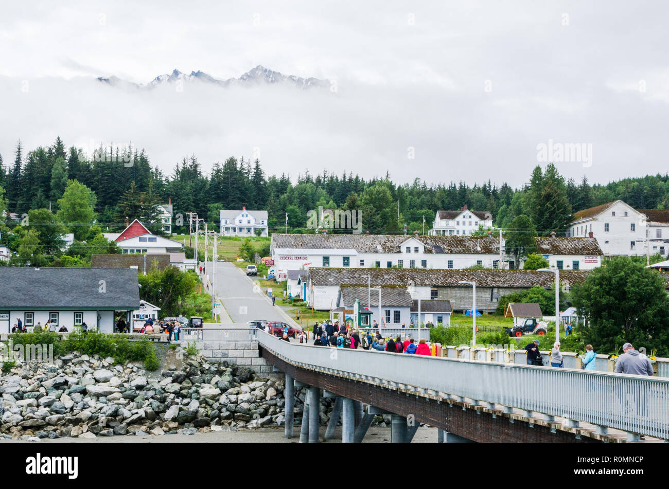 Haines, Alaska, USA 6/6/2017: Tourists from cruise ship walk down wharf ...