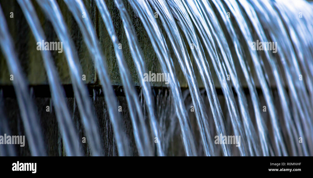 Clear water streaming from an outdoor fountain Stock Photo - Alamy