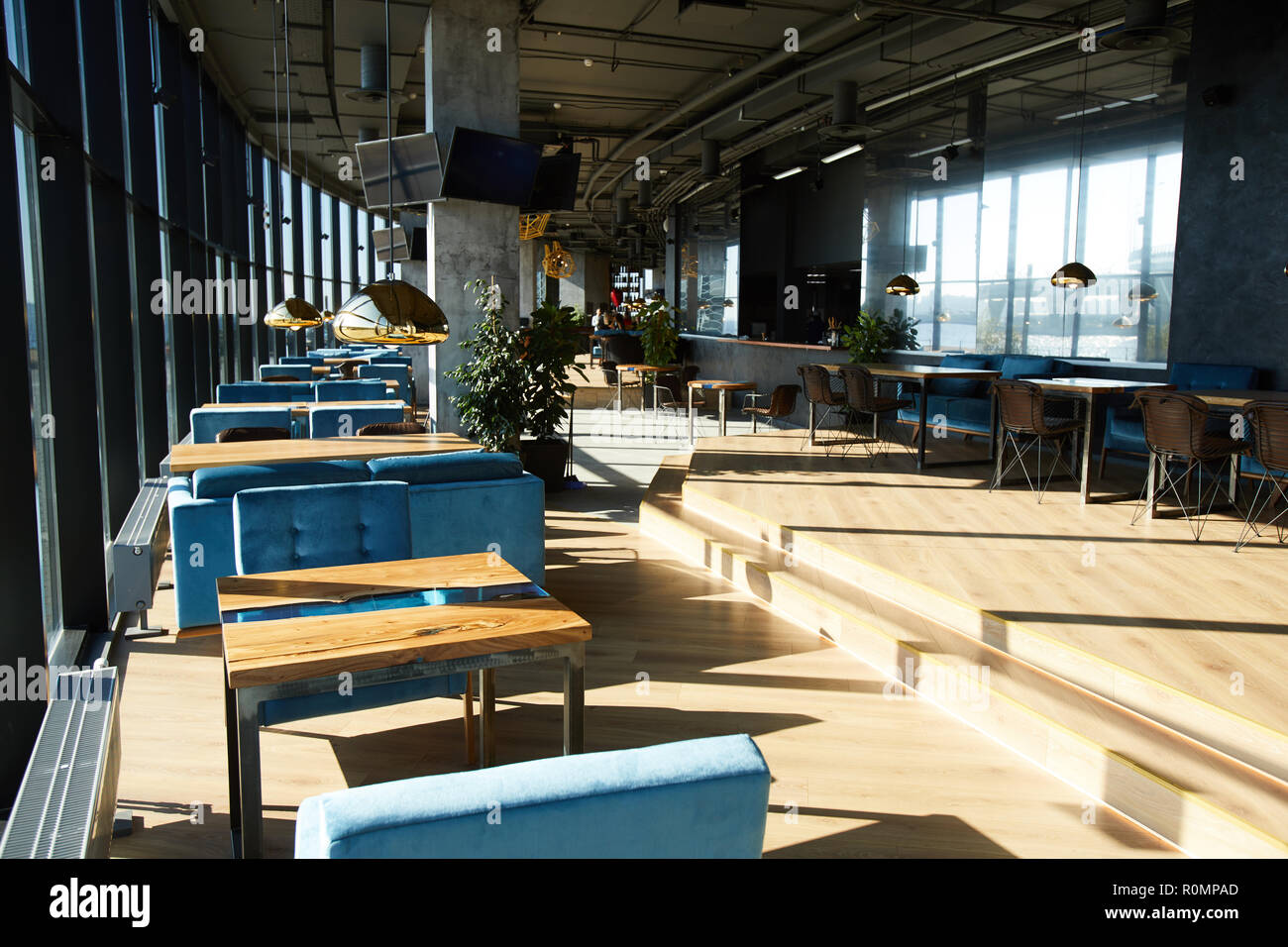Sunlight penetrating through cafe window on wooden floor and furniture ...