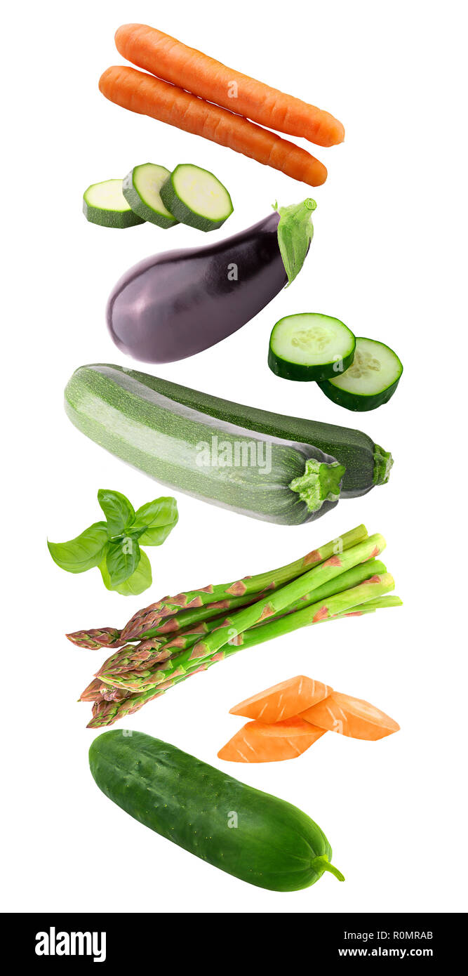 Fresh flying vegetables ingredients isolated on a white background ...