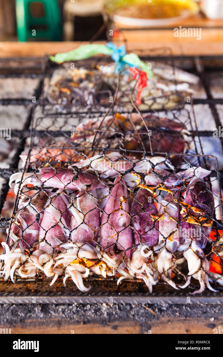Grilled fresh seafood: parrot fish, octopus, shrimp food background ...