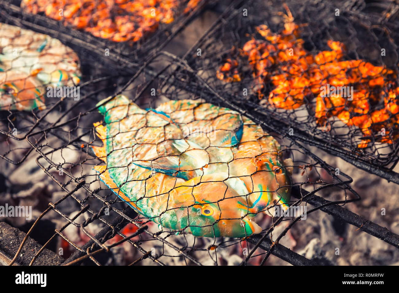 Grilled fresh seafood: parrot fish, octopus, shrimp food background ...