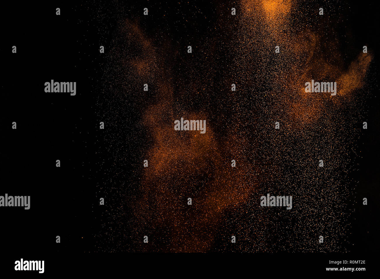 Abstract orange paint Holi. Abstract orange powder explosion on black ...