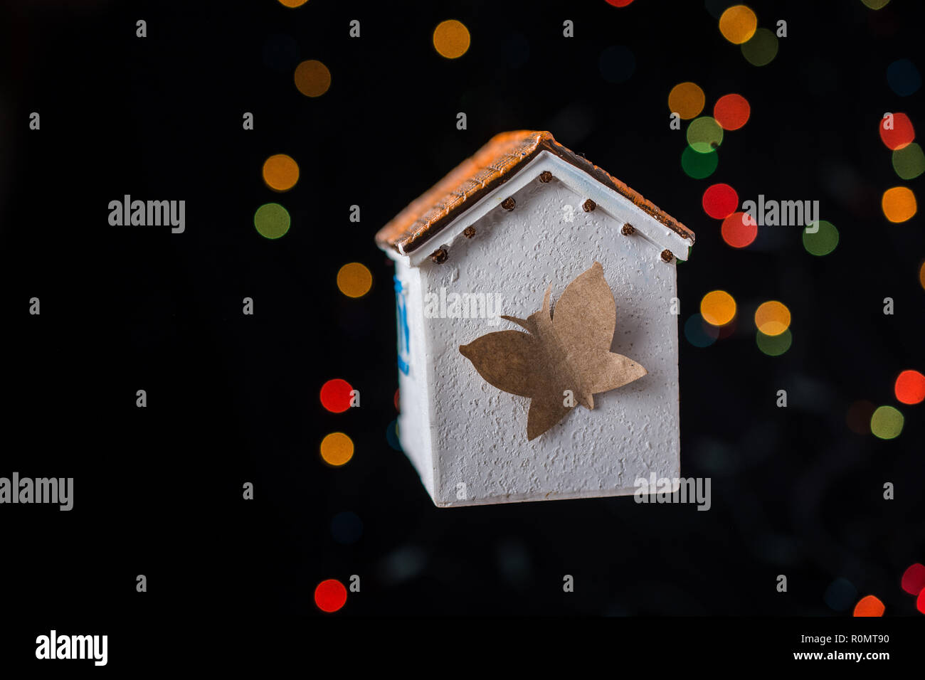 Paper butterfly on a Model house on a bokeh light Stock Photo - Alamy