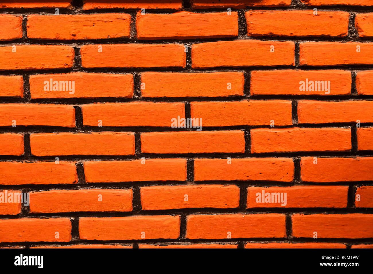 Orange brick wall for background Stock Photo - Alamy