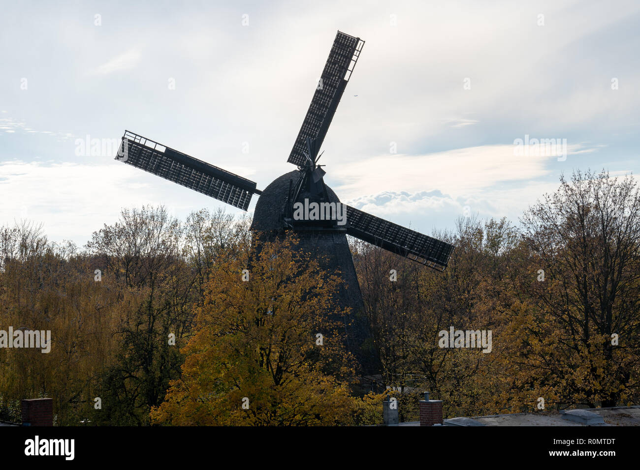 Photography of a Windmill over the Trees Stock Photo - Alamy