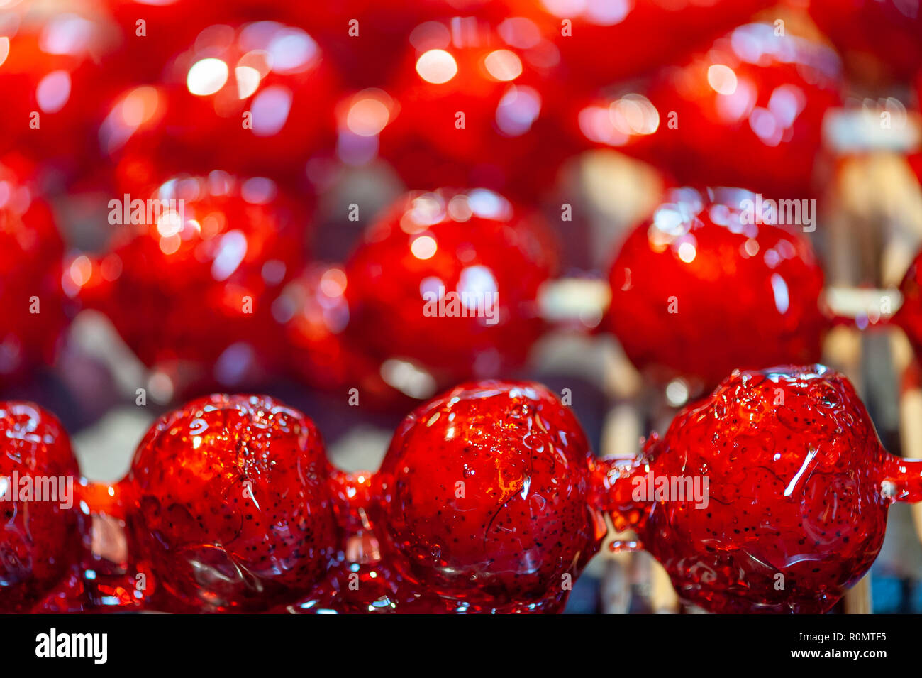 Tanghulu traditional Chinese hard caramel coated fruit skewers close-up ...