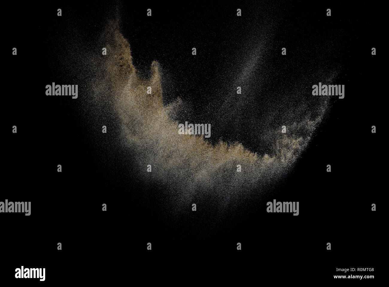 Sandy explosion isolated on black background. Abstract particles cloud ...