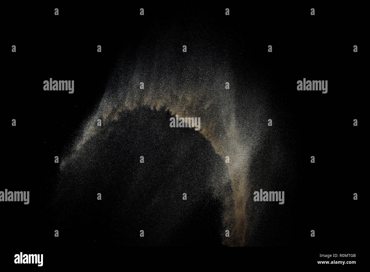 Sandy explosion isolated on black background. Abstract particles cloud ...