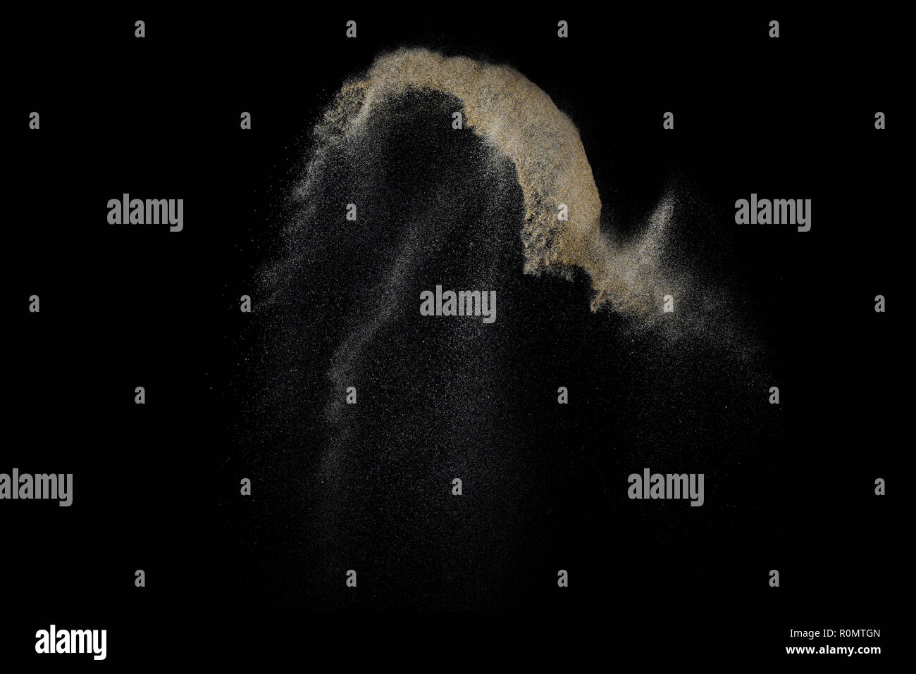 Sandy explosion isolated on black background. Abstract particles cloud ...