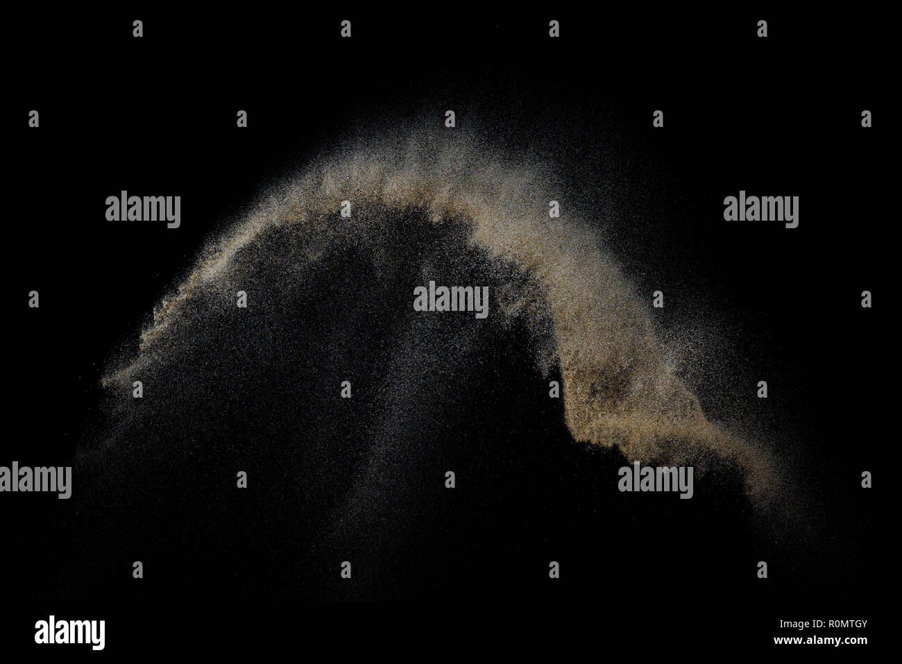 Sandy explosion isolated on black background. Abstract particles cloud ...