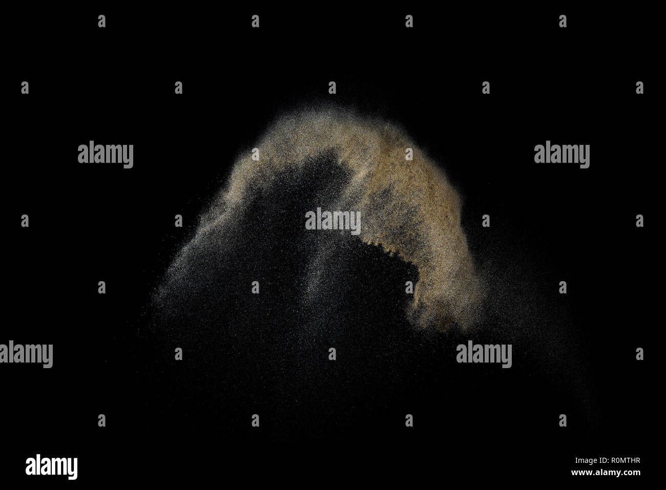 Sandy explosion isolated on black background. Abstract particles cloud ...