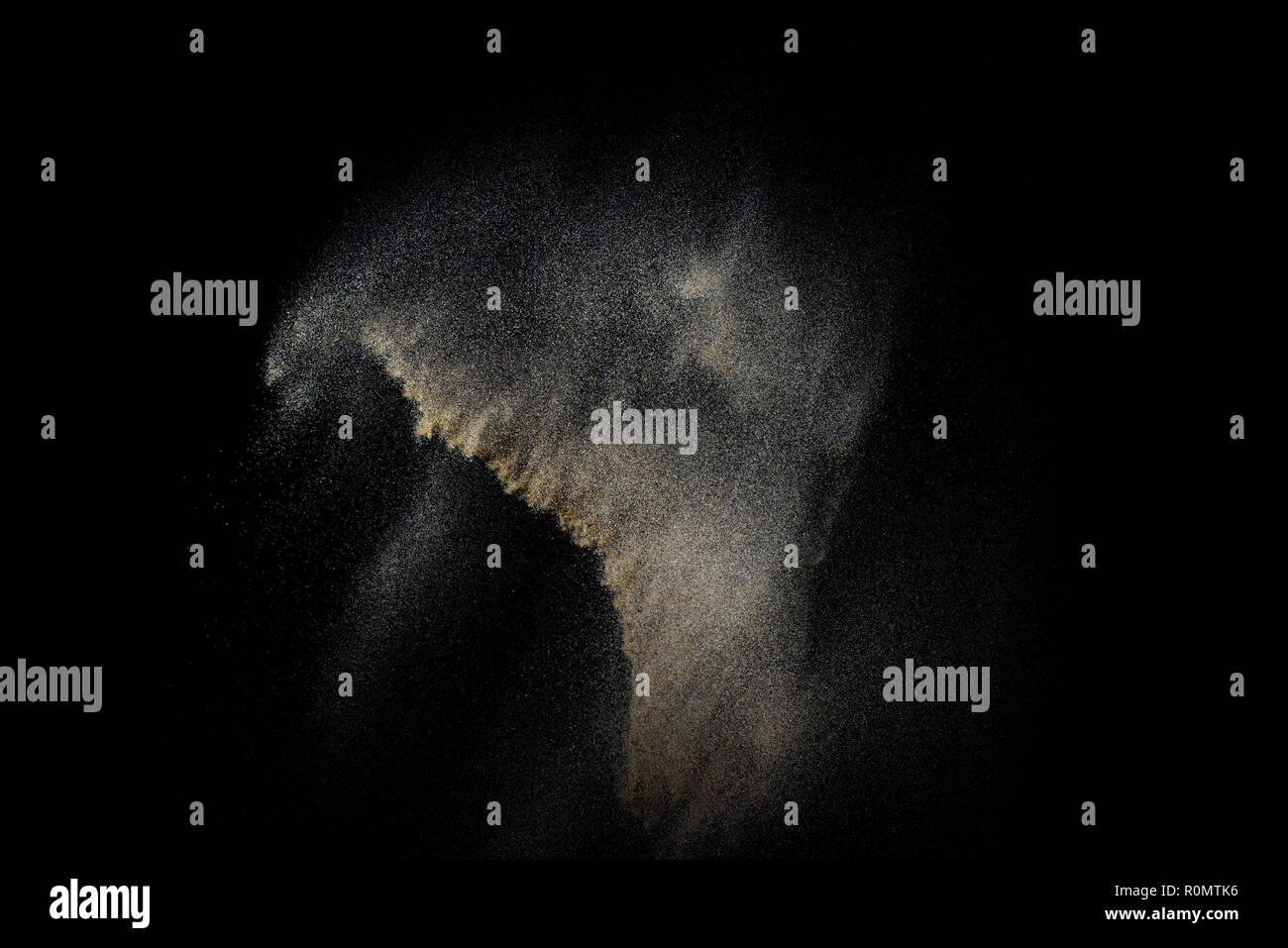 Sandy explosion isolated on black background. Abstract particles cloud ...