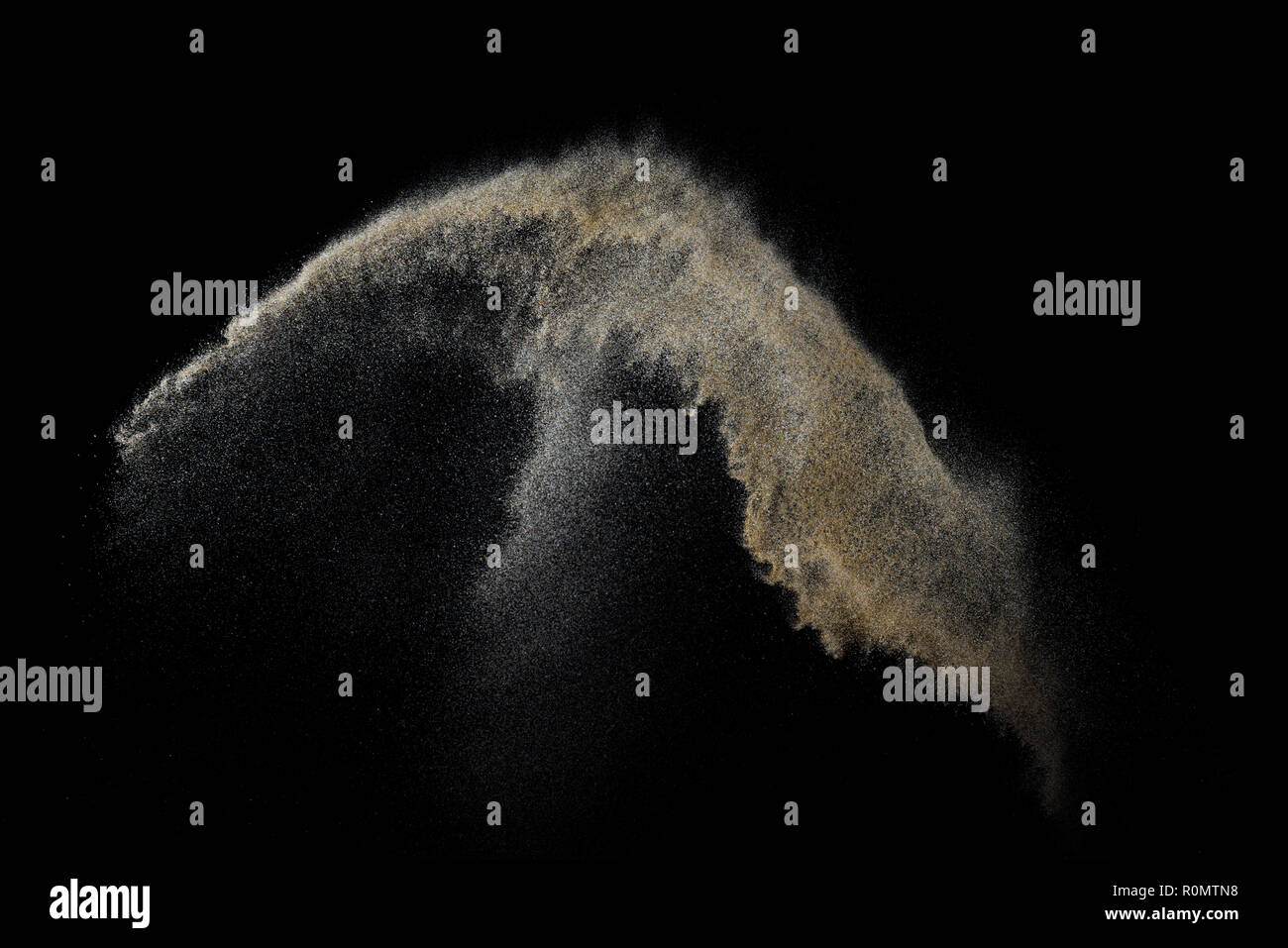 Sandy explosion isolated on black background. Abstract particles cloud ...
