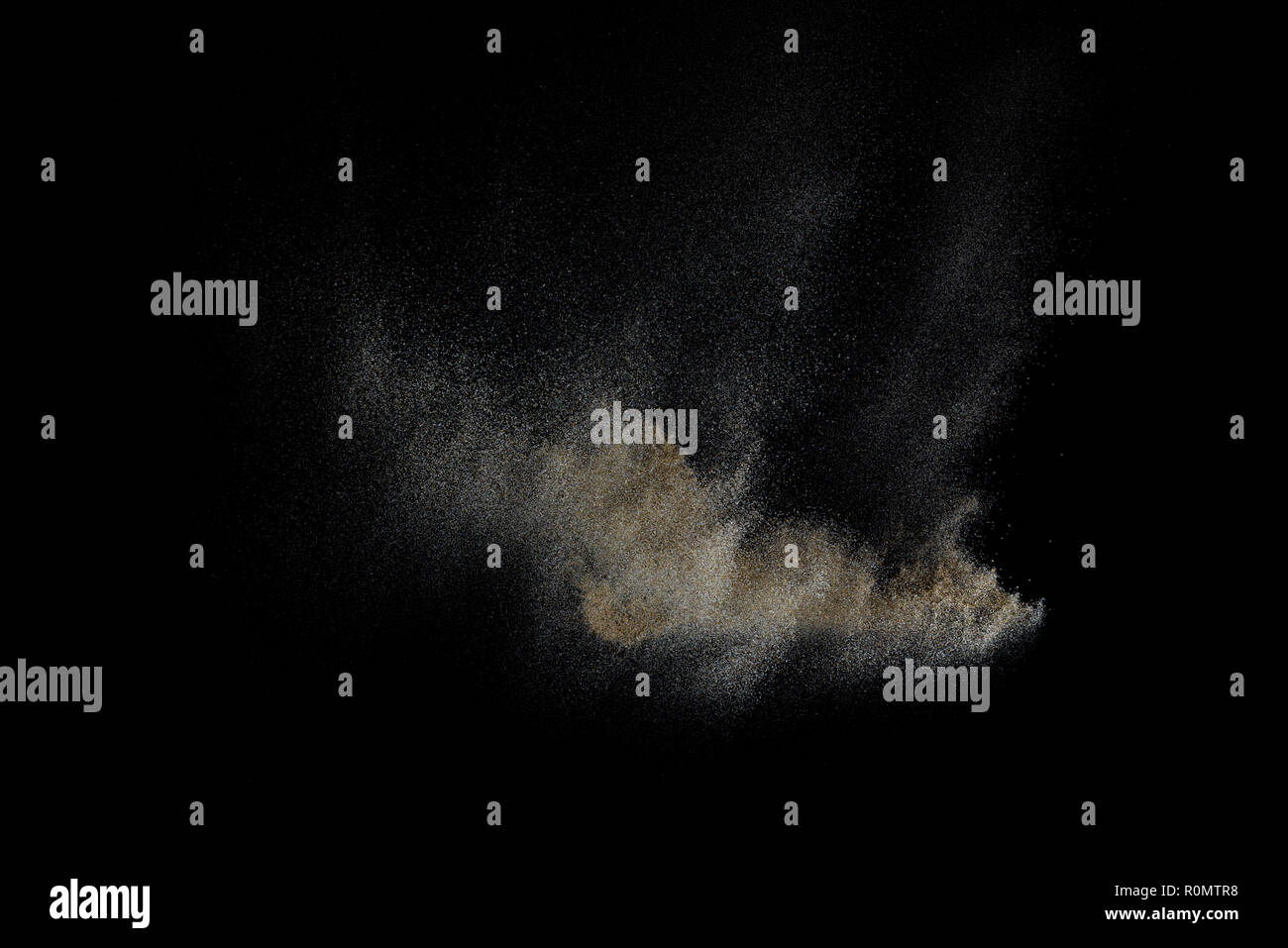 Sandy explosion isolated on black background. Abstract particles cloud ...
