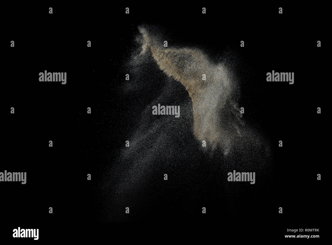 Sandy explosion isolated on black background. Abstract particles cloud ...