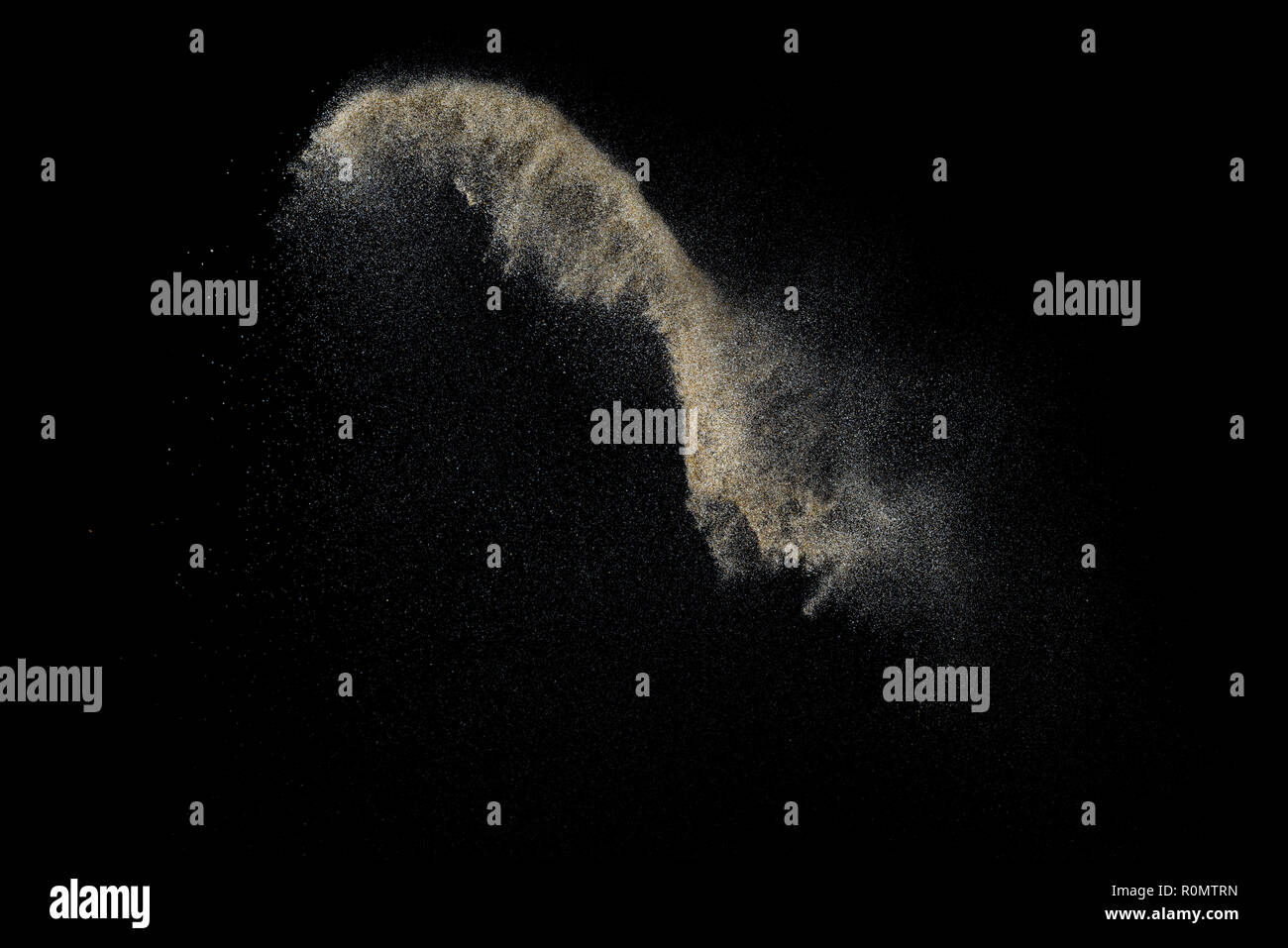 Sandy explosion isolated on black background. Abstract particles cloud ...