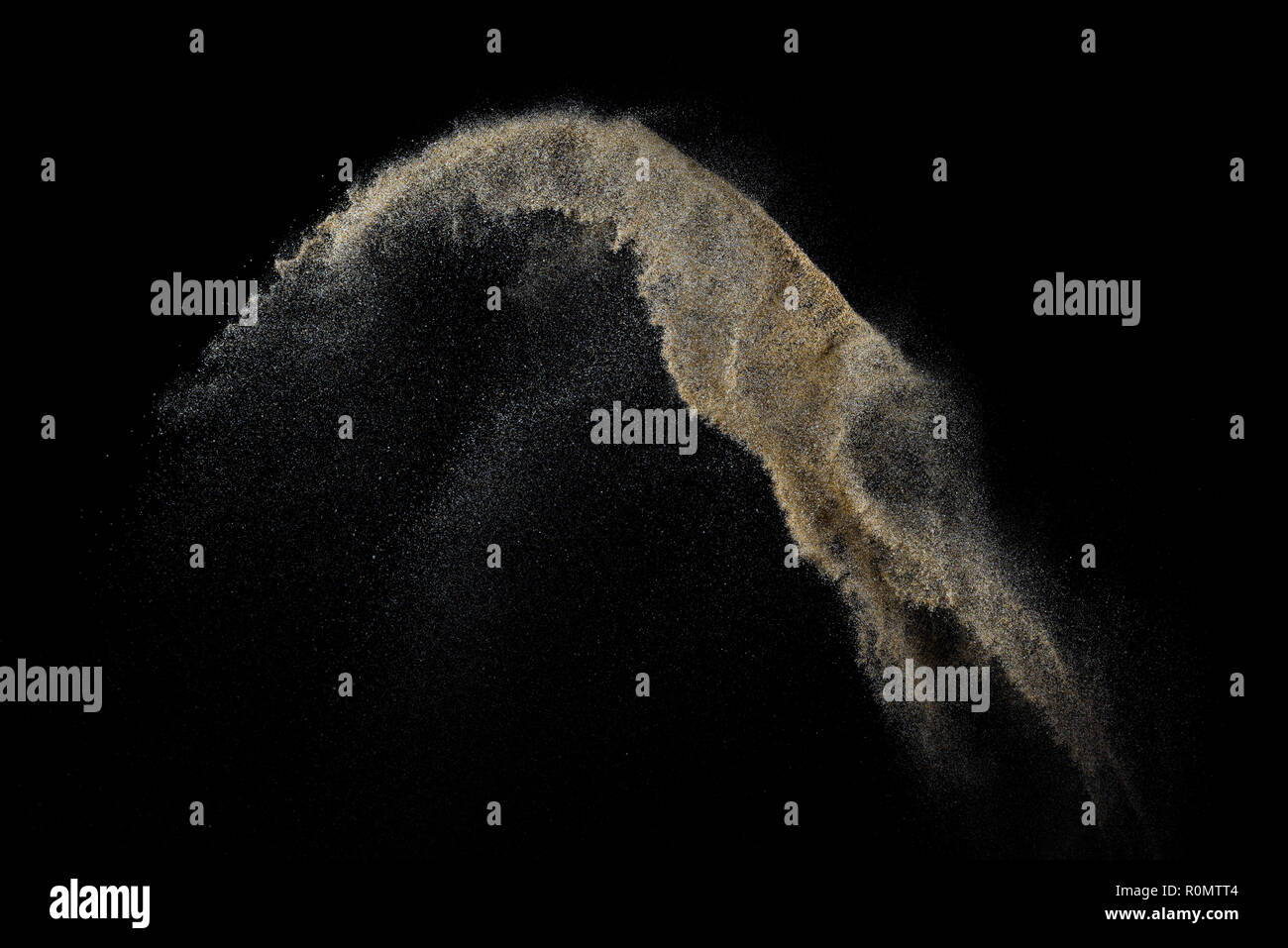 Sandy explosion isolated on black background. Abstract particles cloud ...