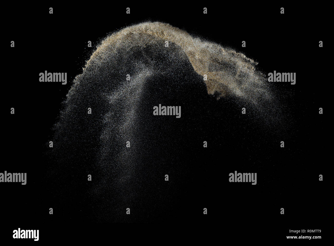 Sandy explosion isolated on black background. Abstract particles cloud ...
