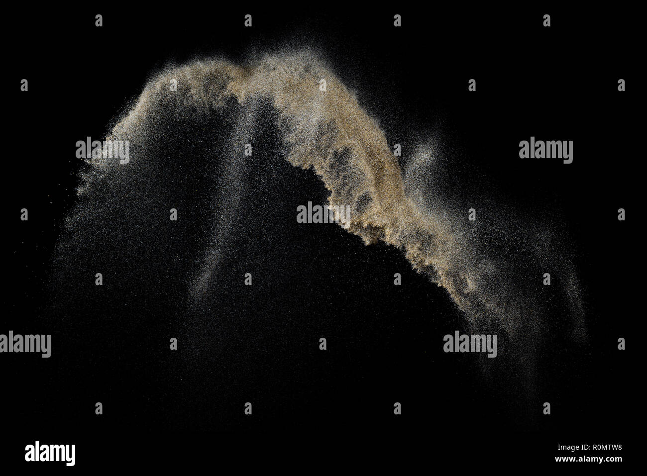 Sandy explosion isolated on black background. Abstract particles cloud ...