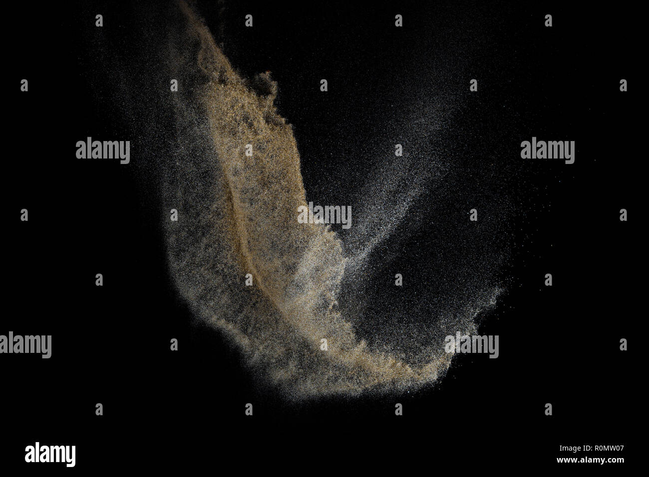 Sandy explosion isolated on black background. Abstract particles cloud ...