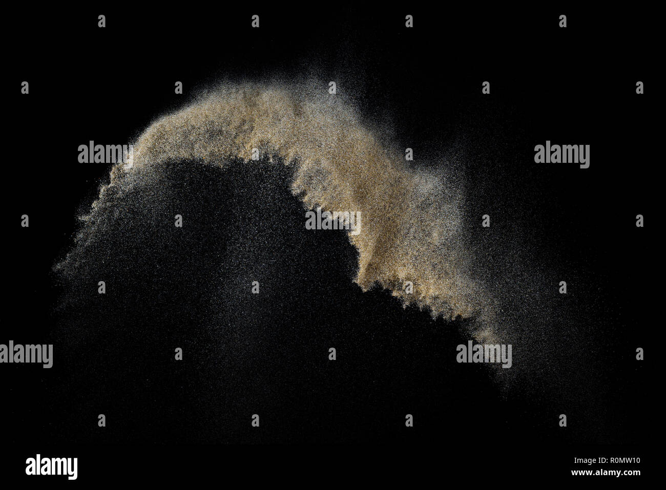 Sandy explosion isolated on black background. Abstract particles cloud ...