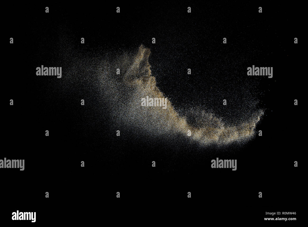 Sandy explosion isolated on black background. Abstract particles cloud ...