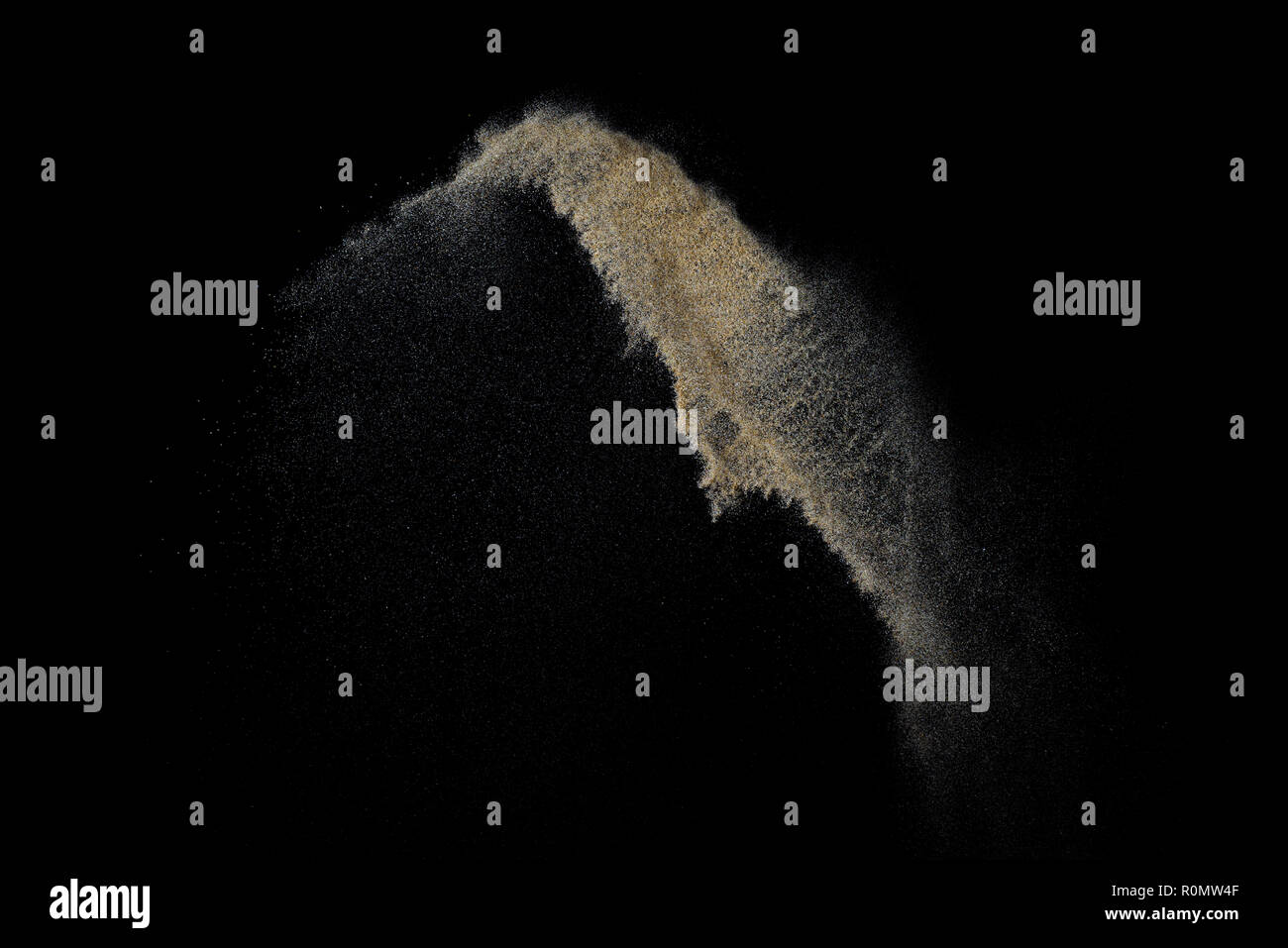 Sandy explosion isolated on black background. Abstract particles cloud ...