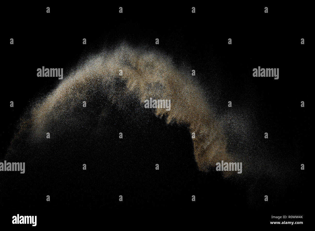 Sandy explosion isolated on black background. Abstract particles cloud ...