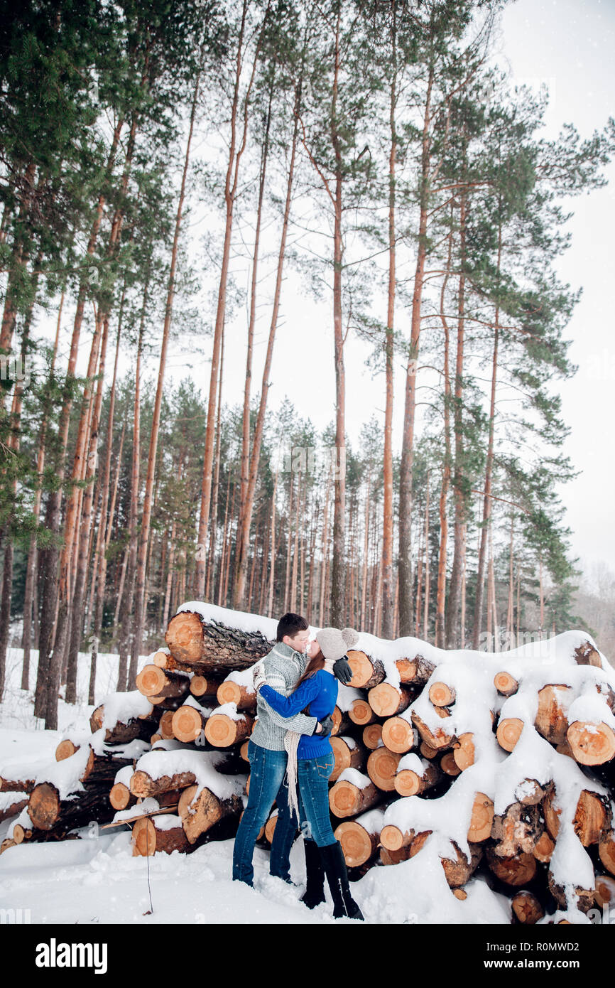 Young couple hugging each other in winter forest. Love story, a ...