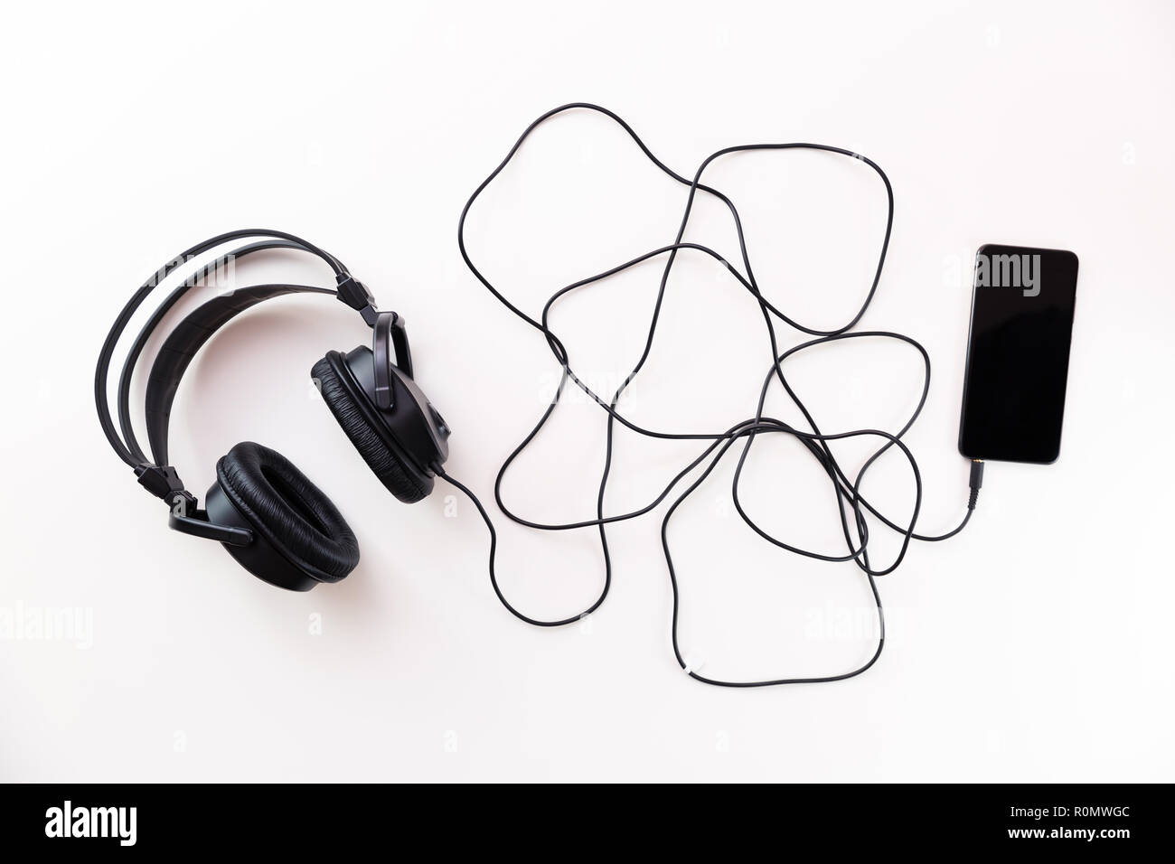 Headphones with a long wire connected to smartphone Stock Photo - Alamy