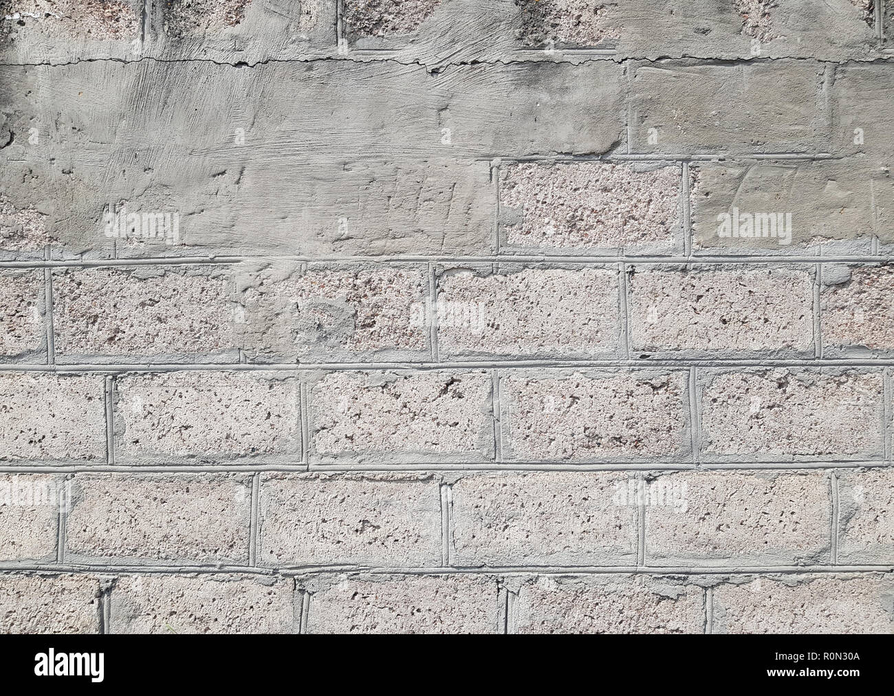 old grey brick wall background. the texture of the masonry is clearly ...