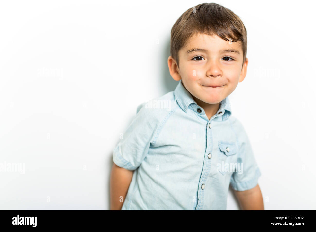 A Boy having fun on studio grey background Stock Photo - Alamy
