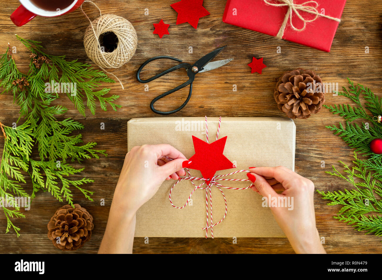 DIY Gift Wrapping. Woman wrapping beautiful red christmas gifts on ...