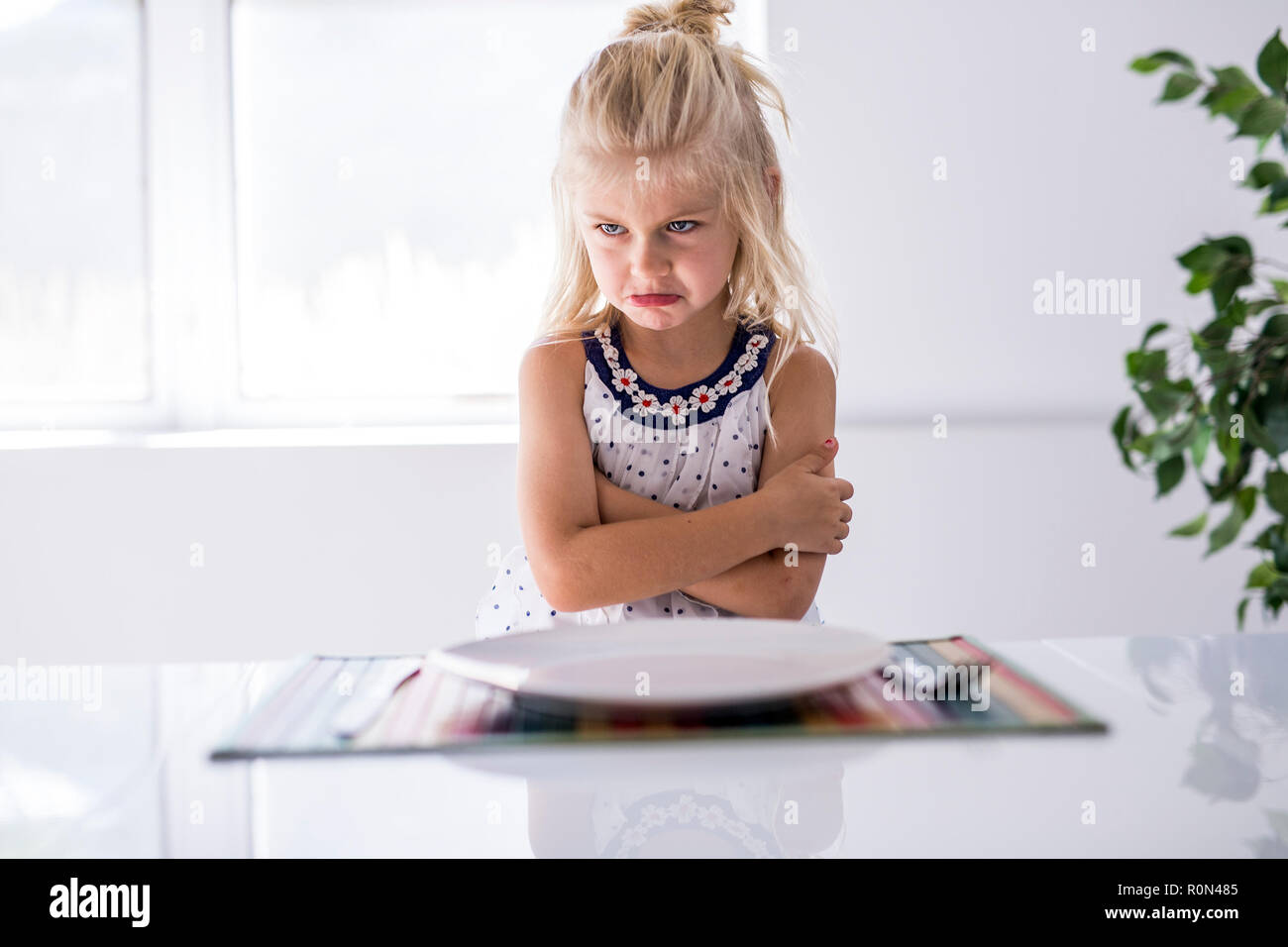 A Furious little girl waiting for dinner Stock Photo - Alamy