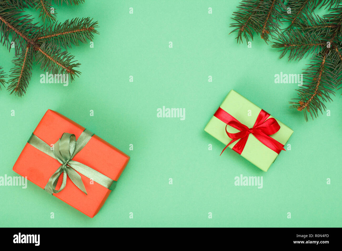 Christmas decoration. Gift boxes and fir tree branches on green ...