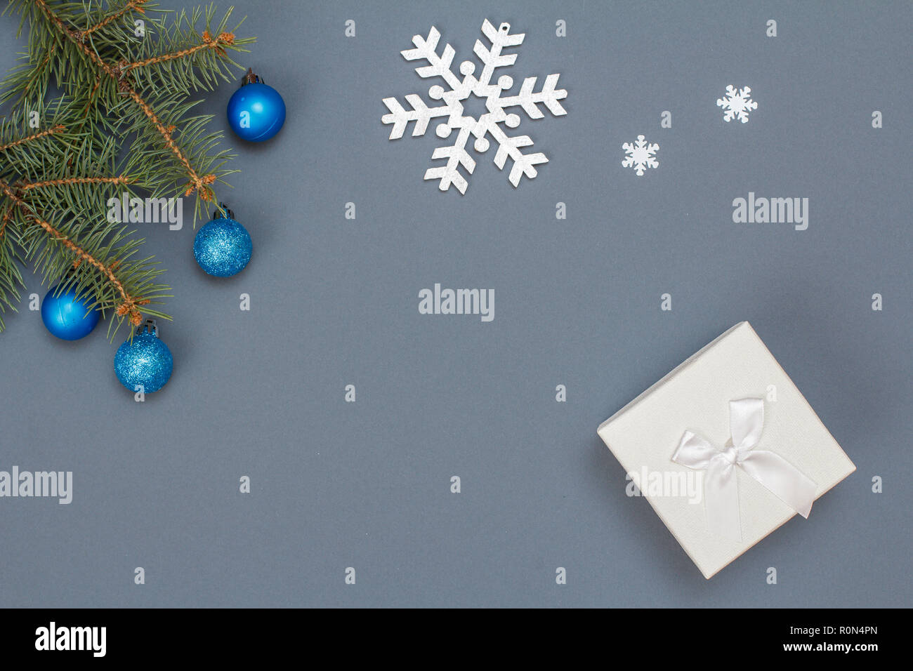 Christmas decoration. Gift box, fir tree branches with toy balls ...