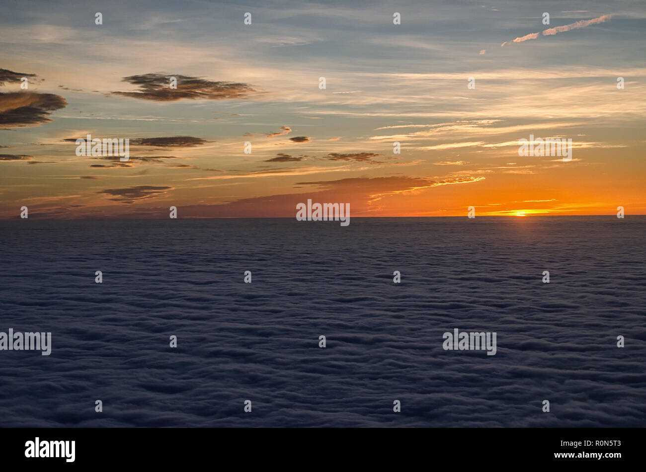 sun setting in the sea of clouds with beautiful and colorful sky above ...