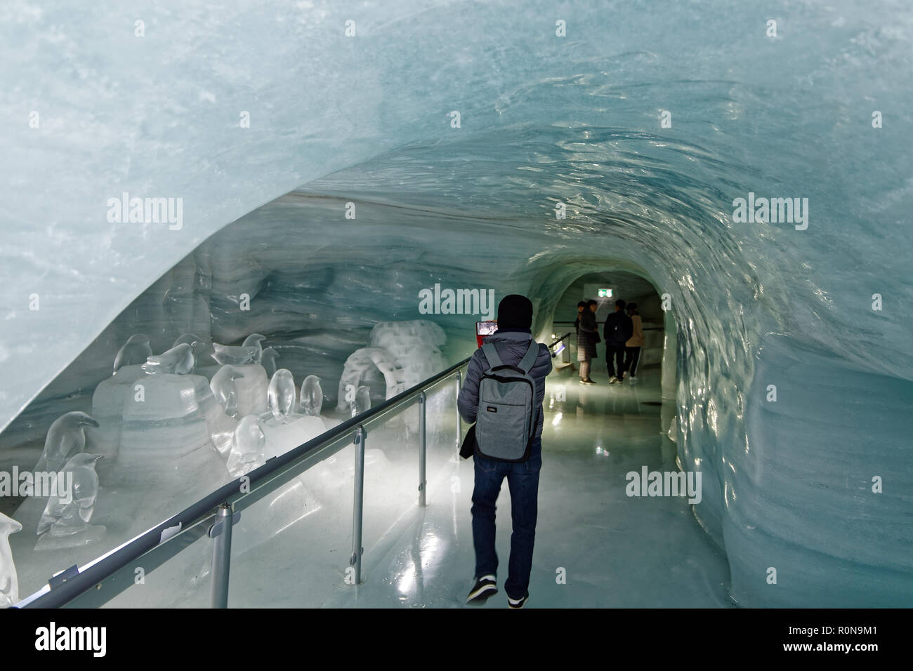Asian tourist exploring the Ice Palace at Top of Europe - Jungfraujoch ...