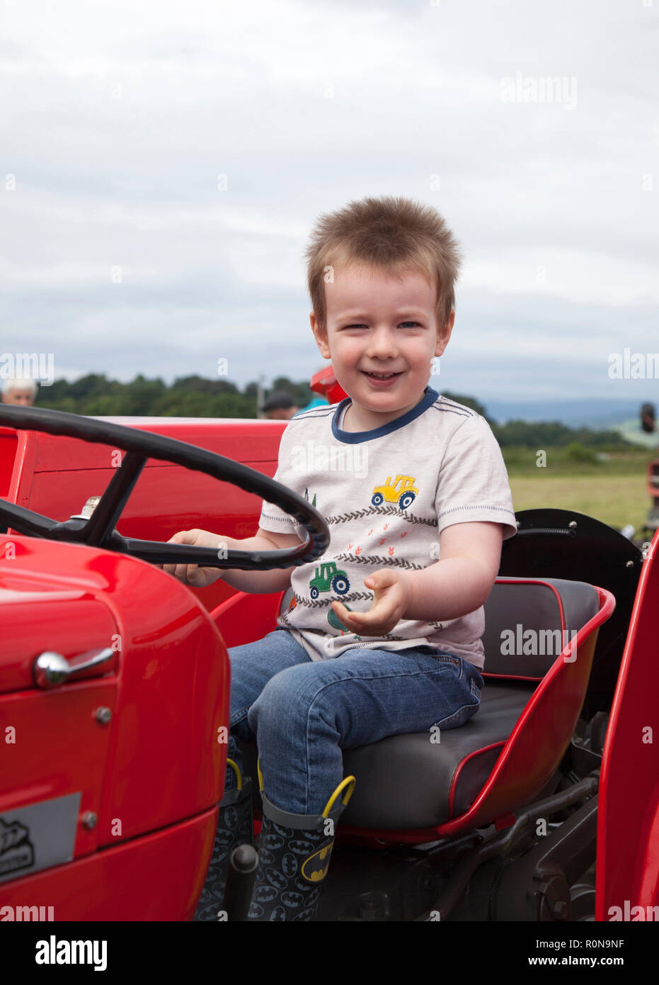 Boy driving tractor hi-res stock photography and images - Alamy