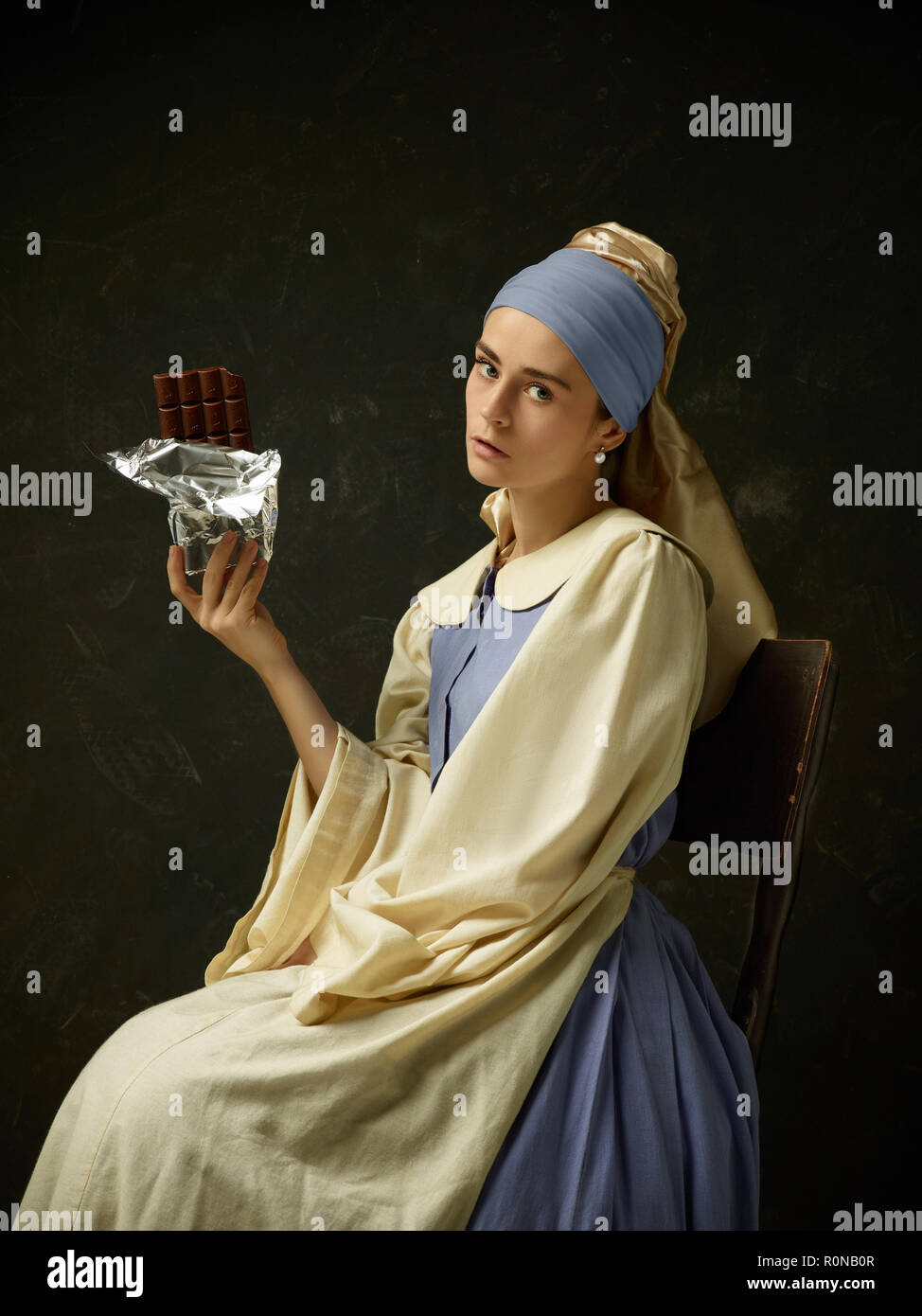 Medieval woman in historical costume wearing corset dress and bonnet ...