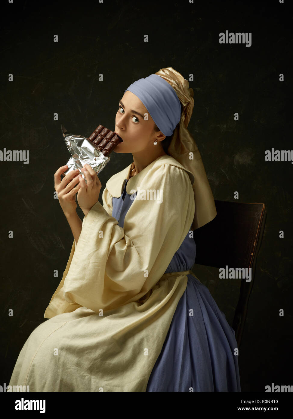 Medieval woman in historical costume wearing corset dress and bonnet ...