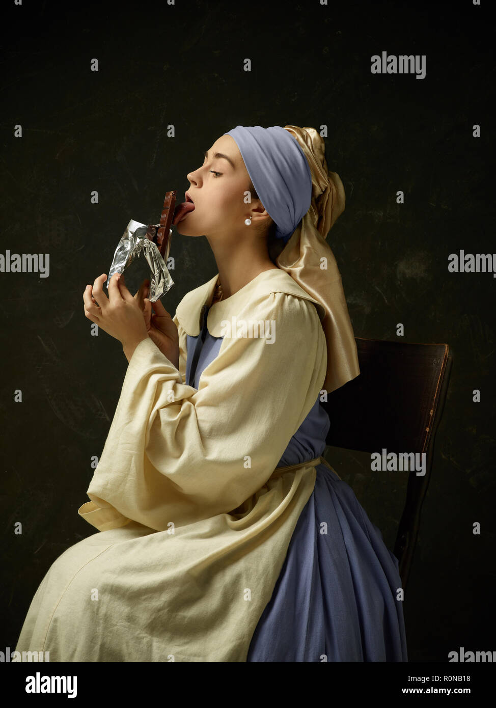 Medieval woman in historical costume wearing corset dress and bonnet ...
